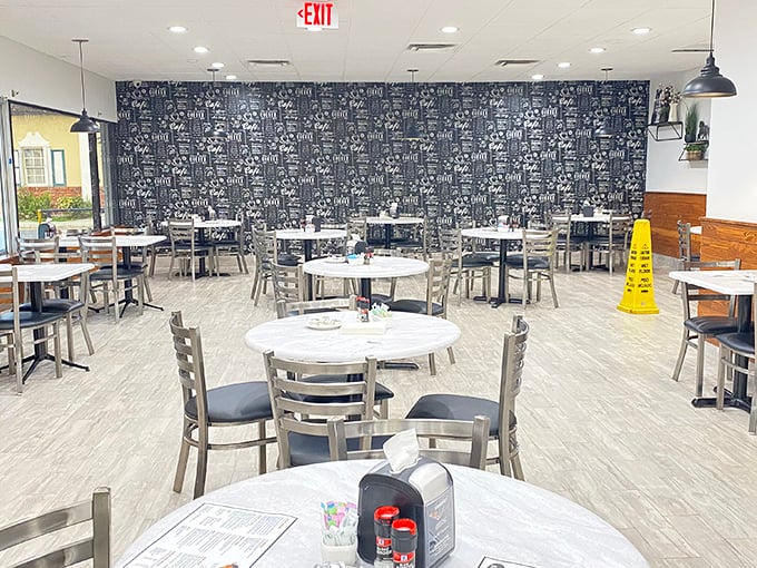 Modern meets nostalgic in this thoughtfully designed dining space. That feature wall isn't just decoration—it's a visual menu teasing what awaits your taste buds.