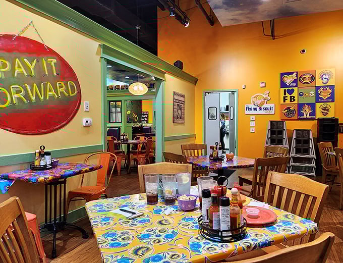"Pay It Forward" isn't just a wall slogan—it's the spirit that fills this cheerful space where colorful tablecloths compete with the sunny walls for brightest spot.