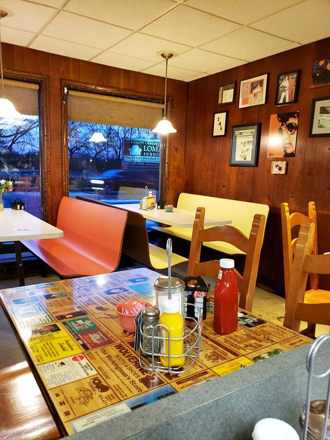 Wood-paneled walls and coral booths tell stories older than most menu items. This isn't retro by design—it's authentic by survival.