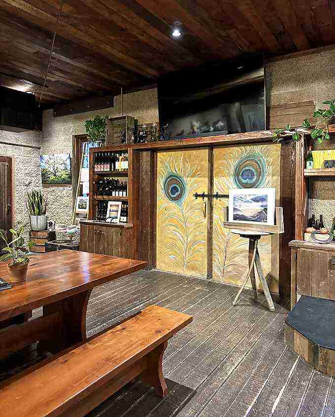 Inside, time stands still – rough-hewn wood, stone walls, and those whimsical peacock doors create an atmosphere no designer could replicate if they tried.