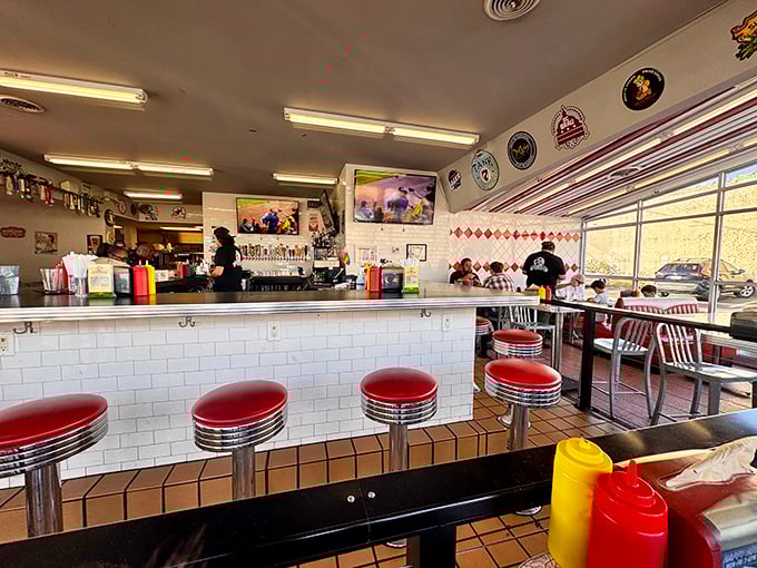 Classic diner vibes with a modern twist. Those red counter stools aren't just for show—they're front-row seats to burger artistry in action.