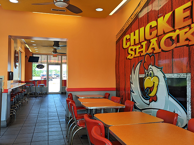 Inside, bright orange tables and red chairs create a cheerful backdrop for serious eating. This isn't ambiance—it's happiness with furniture.