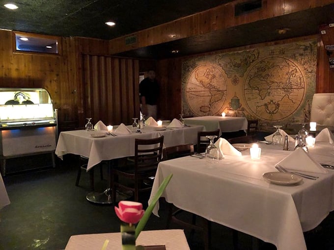 Step inside and time travel to the 1960s, where wood paneling, vintage maps, and white tablecloths create the perfect backdrop for serious steak consumption.