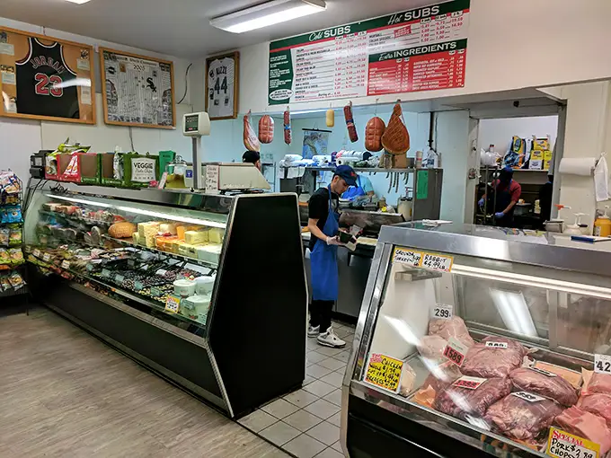 Behind the counter, culinary magic happens with practiced precision. This isn't dinner theater—it's lunch artistry in its purest form.