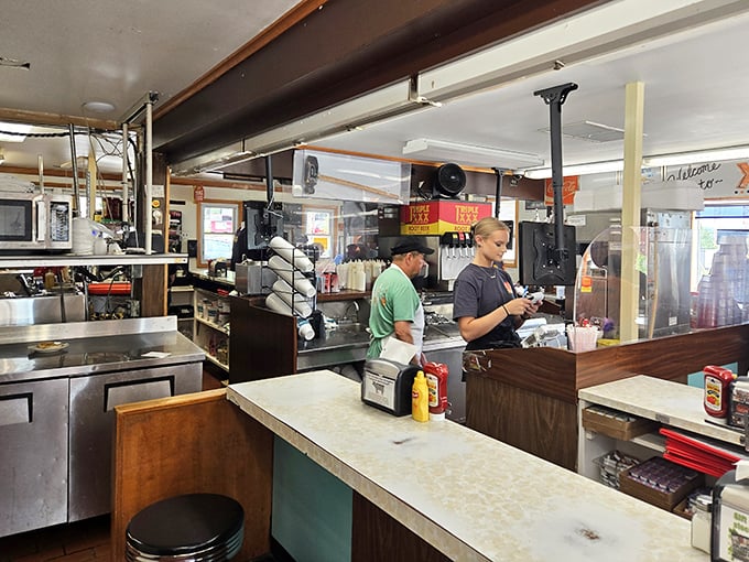Where the magic happens! The open kitchen design lets you watch your burger journey from raw patty to life-changing meal while counter seating encourages friendly conversation.