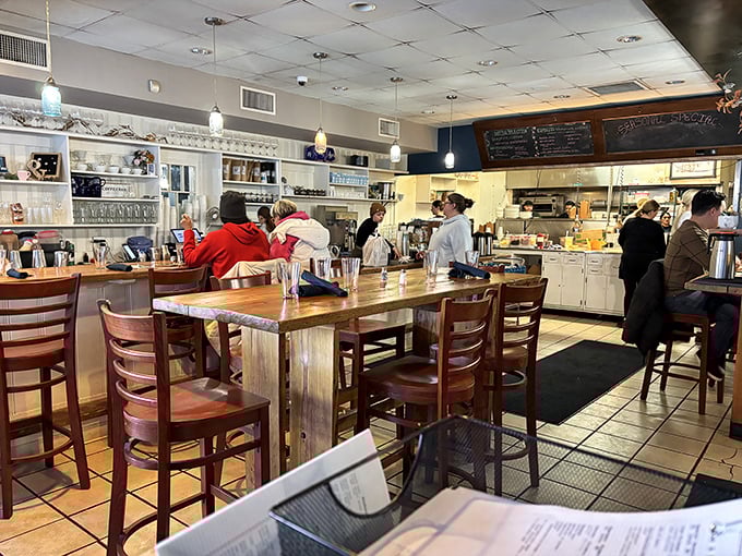 Where breakfast dreams come true – the bustling interior combines warm woods and open kitchen views, letting you witness the morning magic unfold.