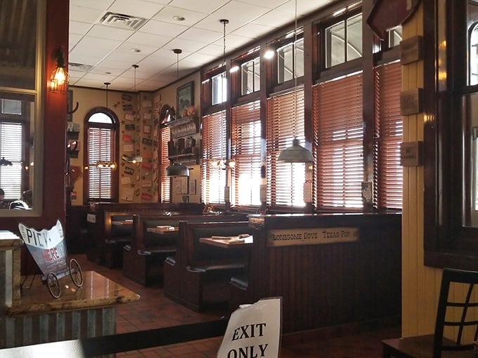 Wooden booths bathed in warm light create intimate dining spaces where conversations flow as freely as the coffee.