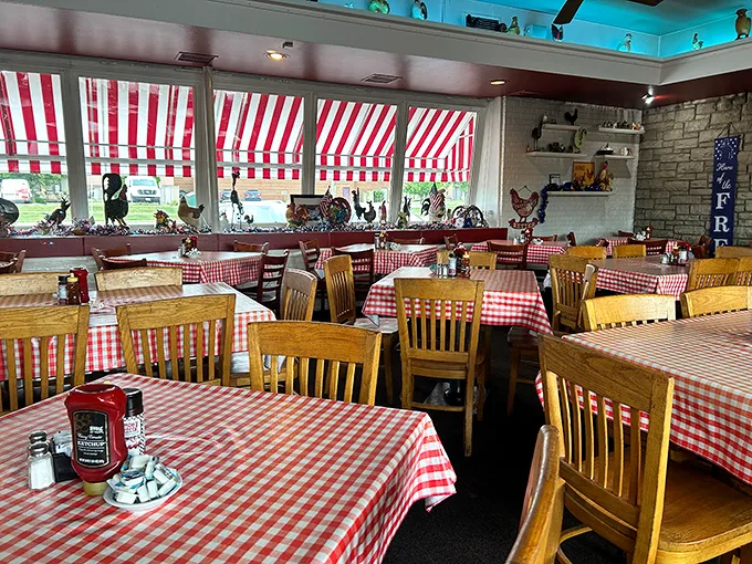 Classic red-checkered tablecloths and wooden chairs set the stage for comfort food theater – no fancy dress code required.