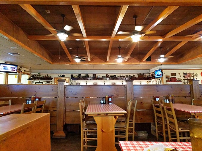 Wooden beams, checkered tablecloths, and booth dividers tall enough for privacy but low enough for community—barbecue architecture at its most functional.