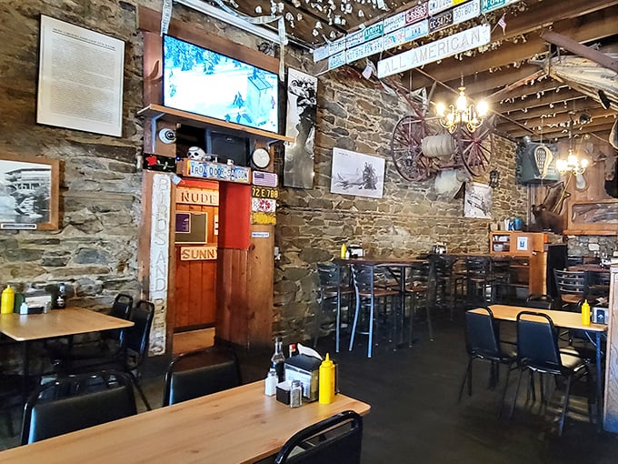 Stone walls that have witnessed a century of conversations frame the rustic dining area where history feels as tangible as the wooden tables.