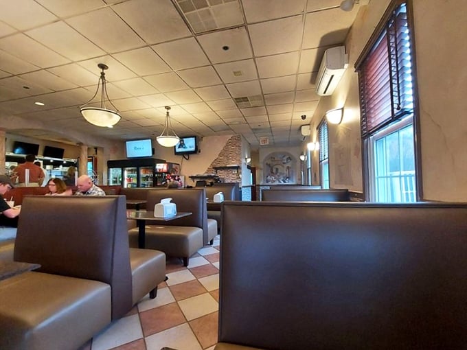 Inside, the cozy booths and warm lighting create that perfect "everybody knows your name" vibe where pizza dreams come true. 