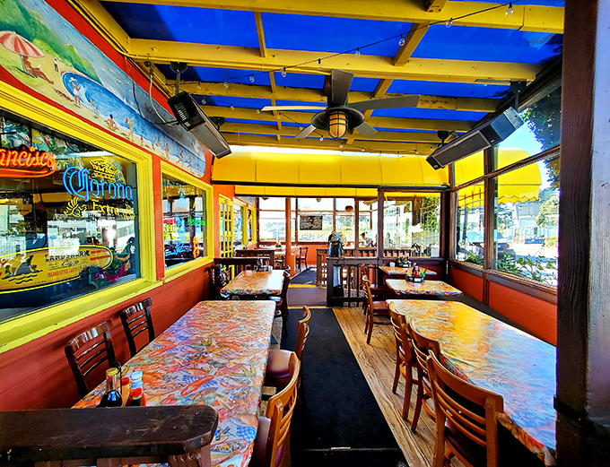 Step inside and you're greeted by a riot of color – yellow beams, vibrant tablecloths, and windows that frame the harbor like living paintings.