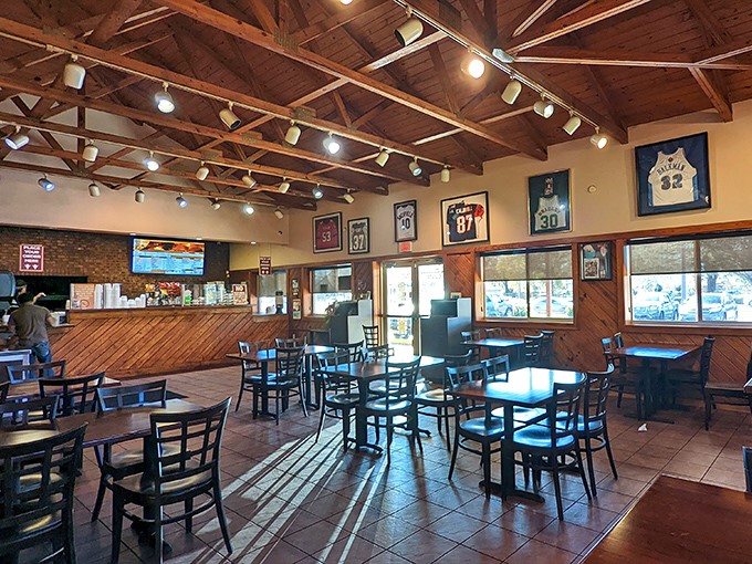 Sports jerseys watch over diners like barbecue guardian angels in this wood-beamed sanctuary of smoke and satisfaction.