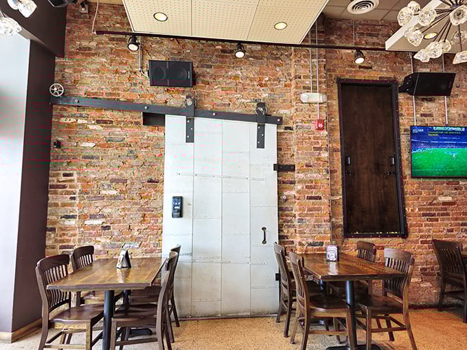 Exposed brick walls and rustic wooden tables create that perfect "I've discovered something special" atmosphere. That sliding barn door isn't just for show—it's a portal to flavor town.