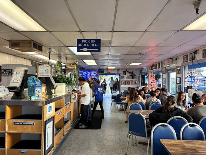 Inside Andria's, the bustling counter service and blue chairs aren't trying to impress anyone—they're just setting the stage for seafood stardom.