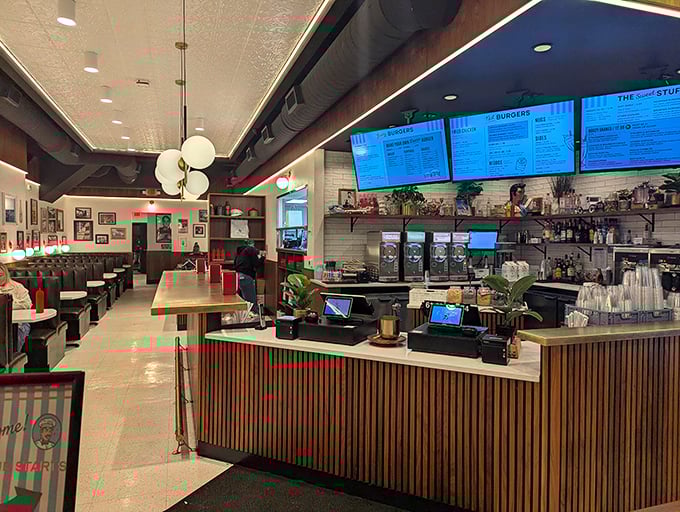 Modern nostalgia at its finest—sleek wood paneling meets digital menus in a space that feels both timeless and perfectly current.
