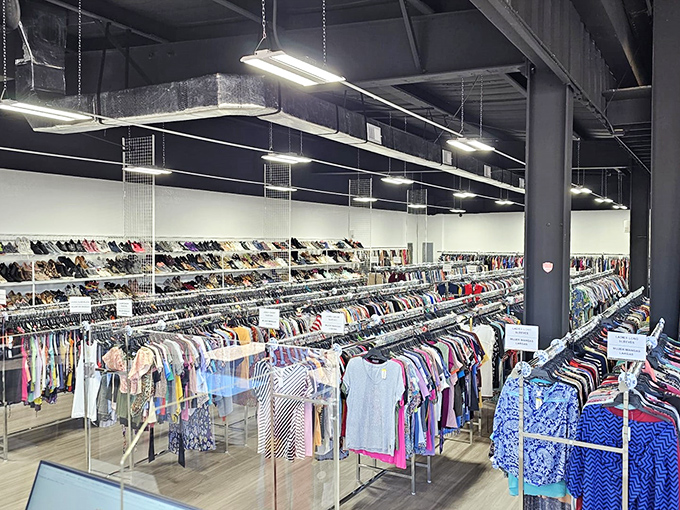 Rows upon rows of meticulously organized clothing stretch toward the industrial ceiling – a fashionista's playground where yesterday's trends await rediscovery.