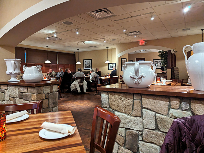 Inside, warm lighting bathes stone accents and wooden tables, creating that perfect "why yes, I would like another breadstick" atmosphere.