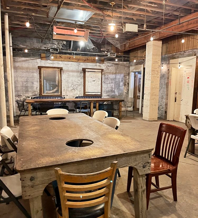 Mismatched chairs around tables with holes for shell disposal – practical poetry in a place where the food, not the furniture, deserves the spotlight.