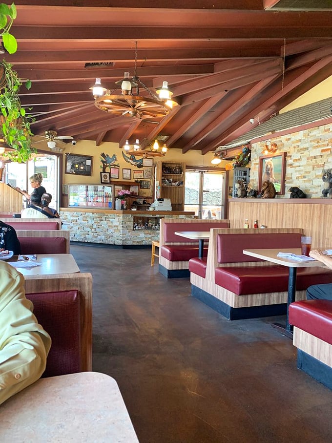Red vinyl booths, wagon wheel chandeliers, and wood-paneled walls—this isn't trendy design, it's barbecue authenticity frozen in delicious time.