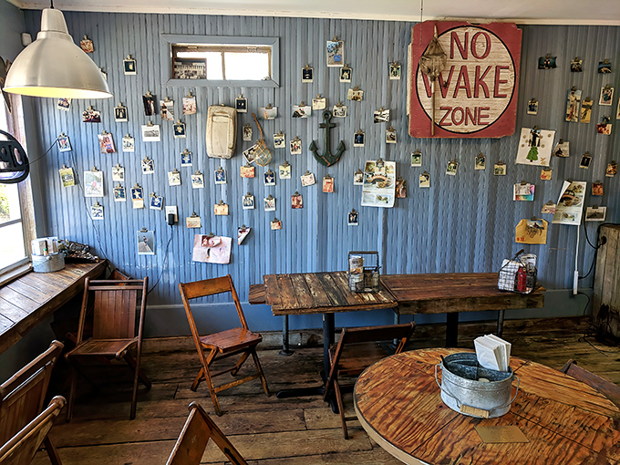 Inside, the "No Wake Zone" sign and photo-covered blue walls tell you everything: slow down, relax, and prepare for seafood that demands your full attention.