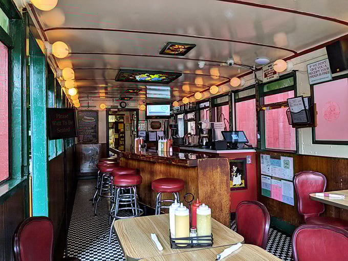Step inside and time travel to a simpler era—this narrow, wood-paneled interior with its classic counter and red vinyl stools has witnessed countless late-night confessions.