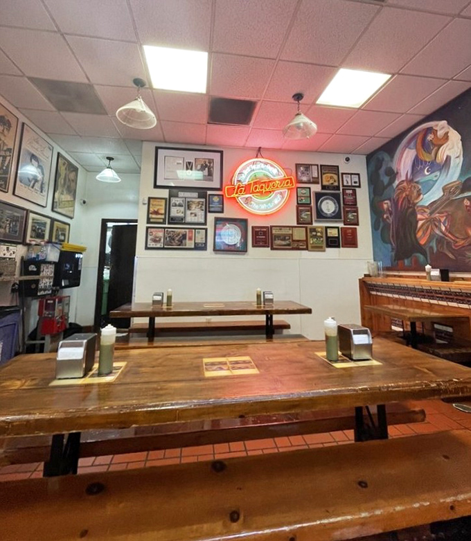 Classic taqueria vibes with wooden tables, neon signs, and walls celebrating decades of delicious memories.