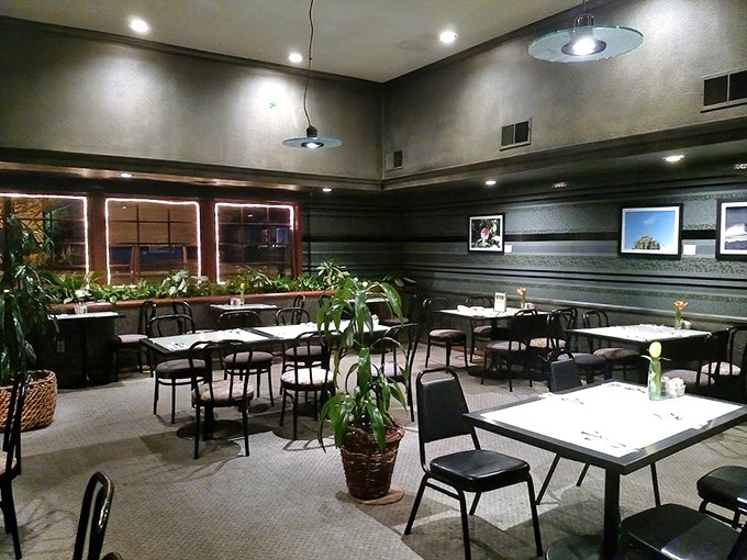 Inside, potted plants and simple tables create that rare dining atmosphere where conversations flow as smoothly as the coffee refills.