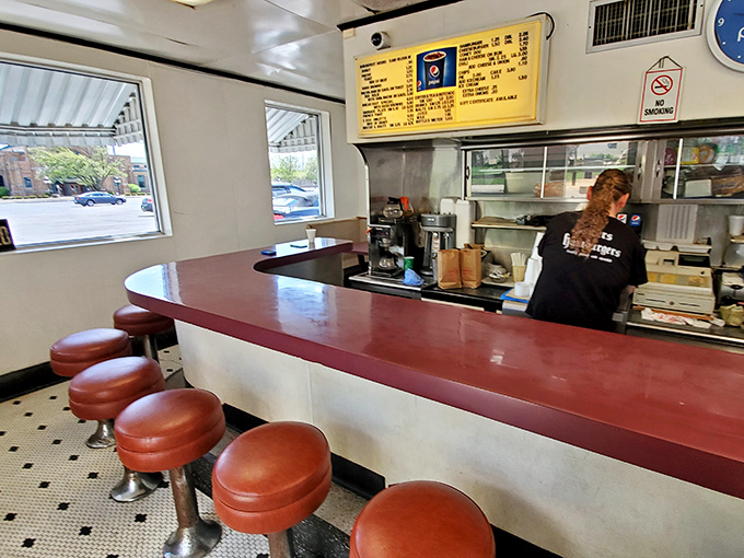 Red vinyl stools line the counter where culinary magic happens. This isn't trendy minimalism—it's the authentic simplicity that's kept locals coming back for generations.