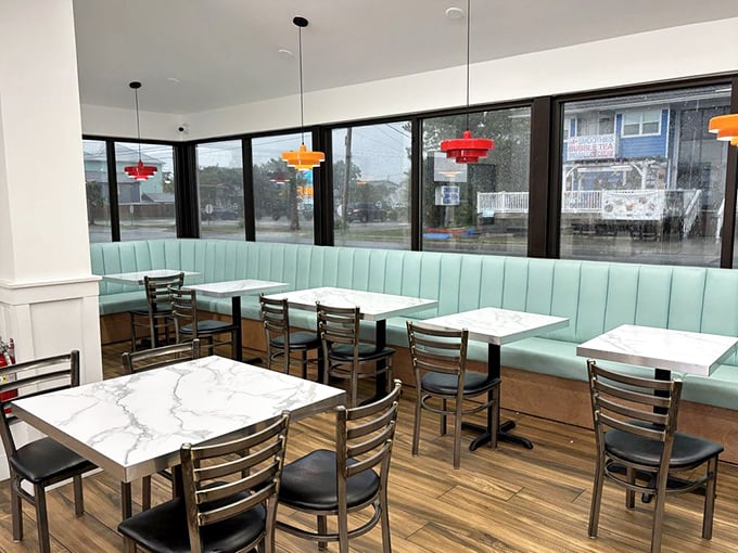 Clean, bright, and ready for burger warfare – where seafoam green booths witness daily battles between humans and impossibly large sandwiches.