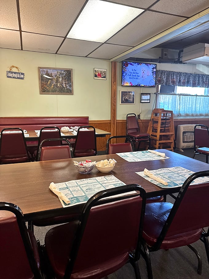Classic diner ambiance with burgundy chairs and wood paneling – where conversations flow as freely as the coffee refills.