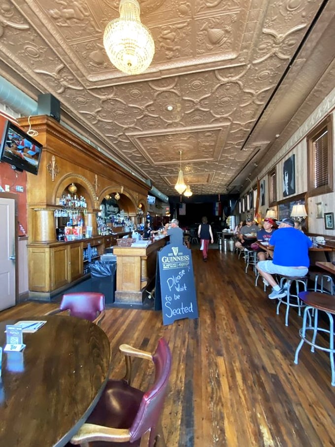Where chandeliers meet conversation. The ornate tin ceiling and warm wooden interior create the perfect backdrop for both casual meetups and special celebrations.