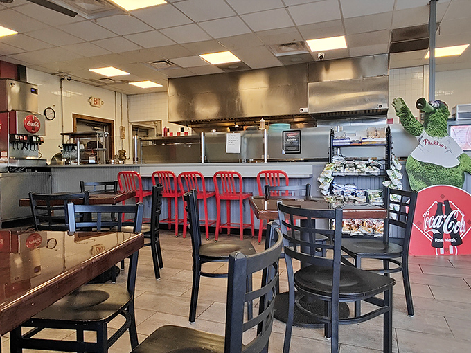 No-frills dining at its finest—red counter stools await the serious sandwich enthusiasts while the Phillie Phanatic stands guard over culinary greatness.