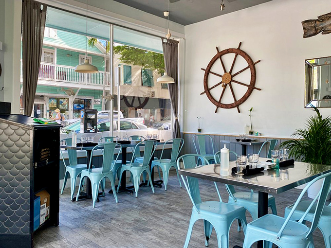 Nautical chic meets Key West casual – those turquoise chairs aren't just pretty, they're the perfect perch for seafood feasting.