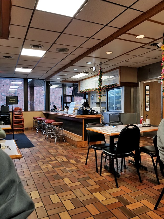 Classic diner aesthetics with wooden floor tiles and counter seating – where conversations flow as freely as the coffee refills.