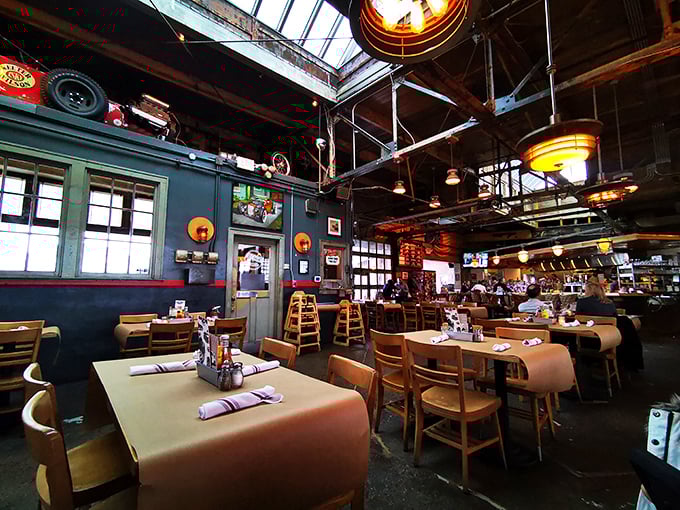 Where mechanics once tuned engines, chefs now orchestrate culinary symphonies. The original skylights and industrial bones create a dining room that remembers its past while serving up the future.