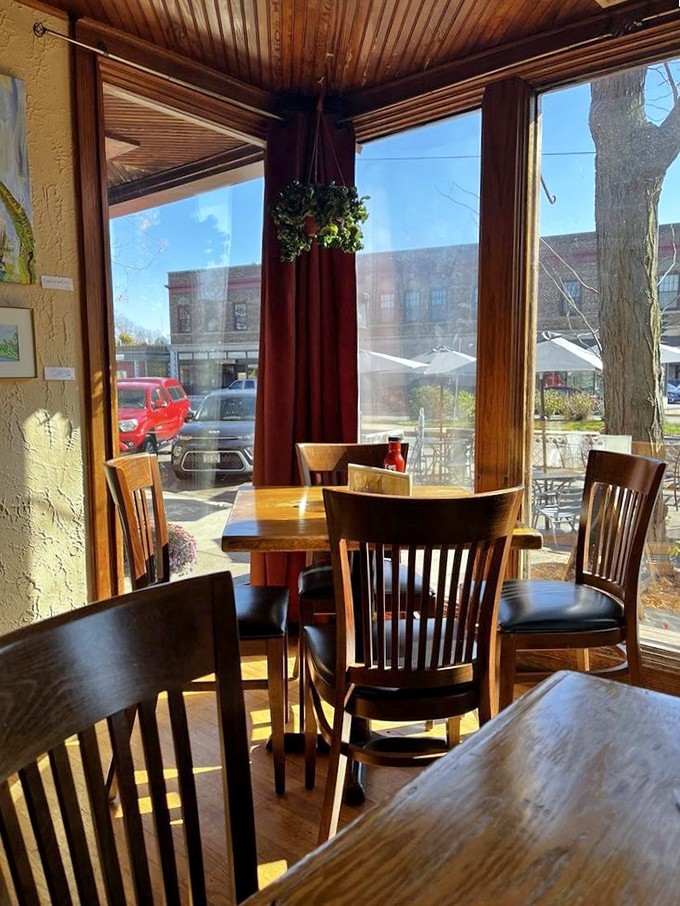 Sunlight streams through windows framing wooden tables where culinary magic happens daily. This corner spot might become your new favorite thinking place.