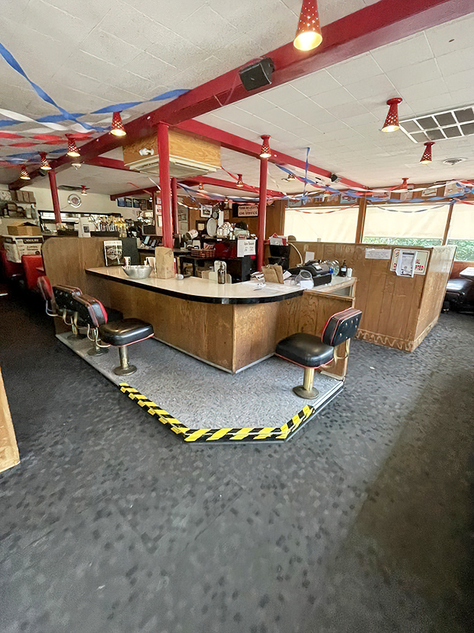 Counter culture at its finest—where swivel stools invite you to belly up to the heart of burger operations while festive streamers keep the mood perpetually celebratory.