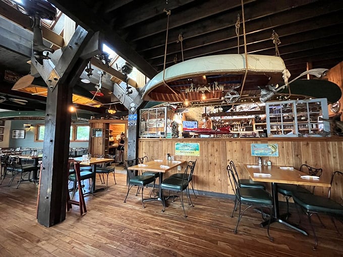 Step inside and you're greeted by exposed wooden beams, nautical treasures, and a canoe suspended from the ceiling—maritime history you can eat beneath.