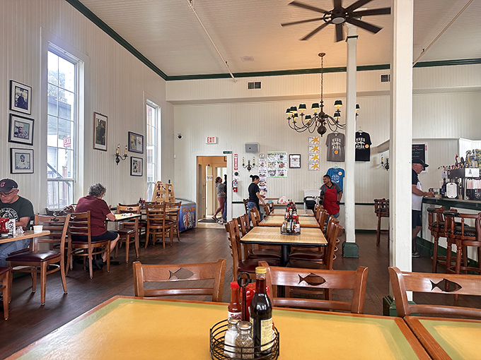 Simple wooden chairs, fish-adorned details, and ceiling fans spinning stories of the sea—Phil's interior feels like dining in a beloved captain's quarters.