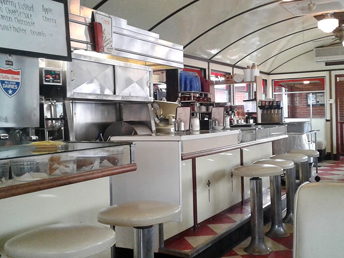 Inside, time stands deliciously still. The curved ceiling, classic counter, and red-and-white checkerboard floor create the perfect backdrop for comfort food conversations.