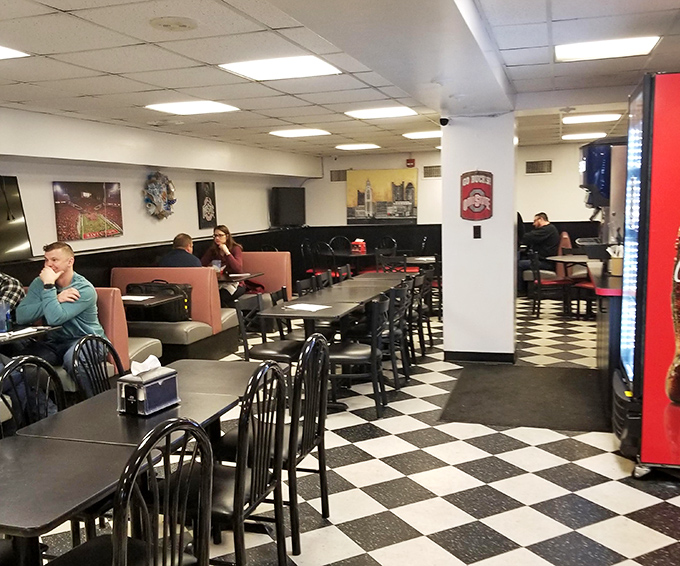 The checkered floor and Ohio State memorabilia create that perfect deli atmosphere where both business deals and family meals unfold with equal comfort.