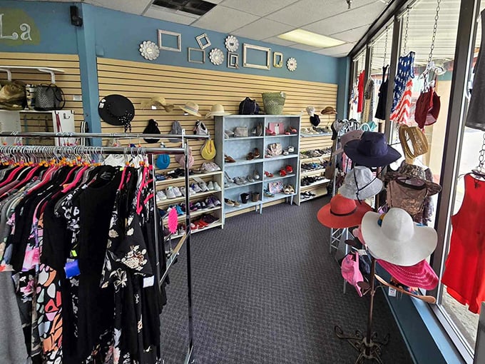 A fashionista's paradise where hats and accessories get the spotlight treatment. That blue wall backdrop? Pure Instagram-worthy retail therapy.