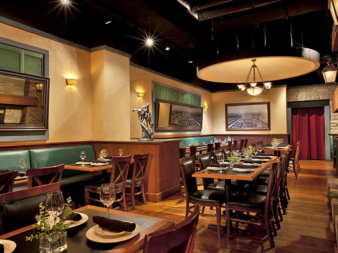 Warm lighting, green leather booths, and rich wood tones create that perfect steakhouse ambiance—like a hug from an old friend who happens to be excellent at cooking.