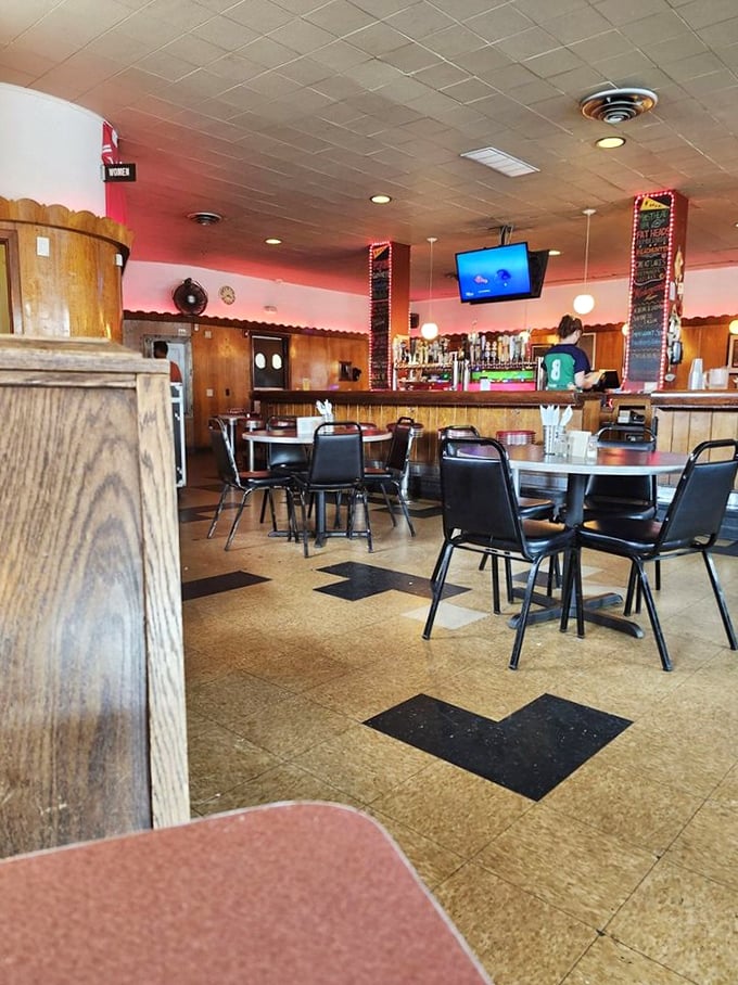 Step inside and you're transported to a cozy time capsule with checkerboard floors and wood paneling that feels like your favorite uncle's basement—if he served amazing hot dogs.