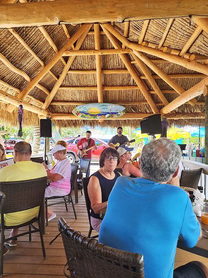 Live music under a thatched tiki roof—where conversations flow as freely as the drinks, and nobody's checking their watch or their stock portfolio.