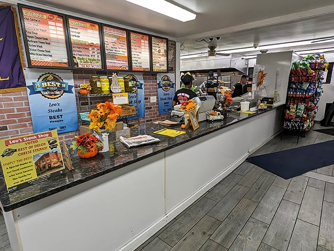 Where sandwich magic happens. The menu board promises delicious possibilities while staff work their craft behind the counter.