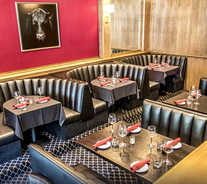 Classic steakhouse elegance meets California cool in these leather booths where conversations flow as smoothly as the cocktails.