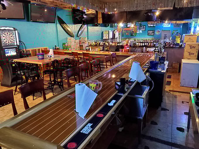 Where tiki meets barbecue: turquoise walls, boat-deck bar, and the promise of island vibes with Southern comfort.