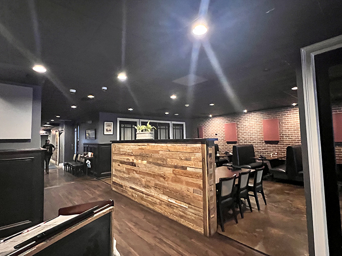 Rustic meets refined in this thoughtfully designed interior where wood paneling and brick walls create the perfect backdrop for memorable meals.